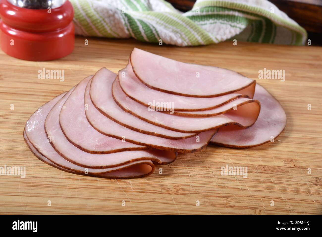 Thin slices of ham on a cutting board Stock Photo - Alamy