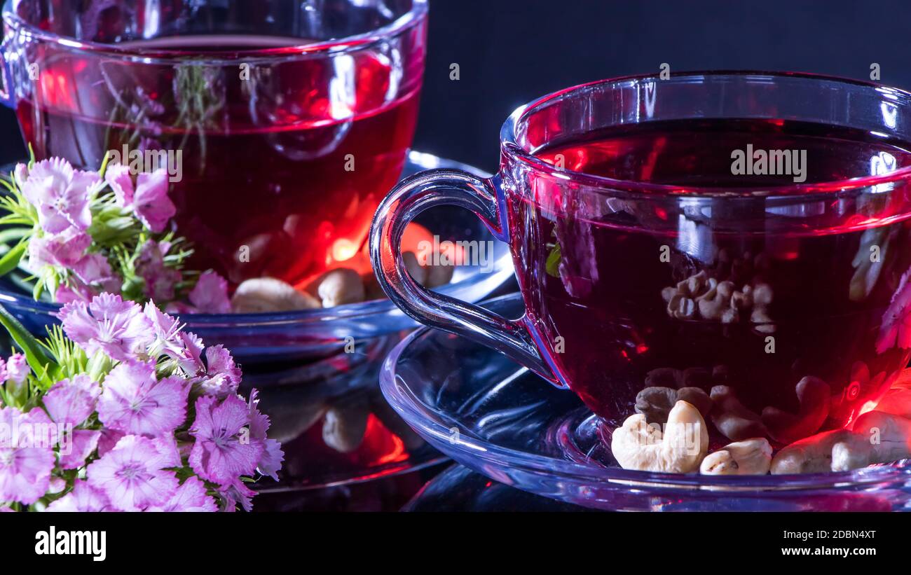 Hibiscus Red tea mug with carnation flowers close-up horizontal photo ...