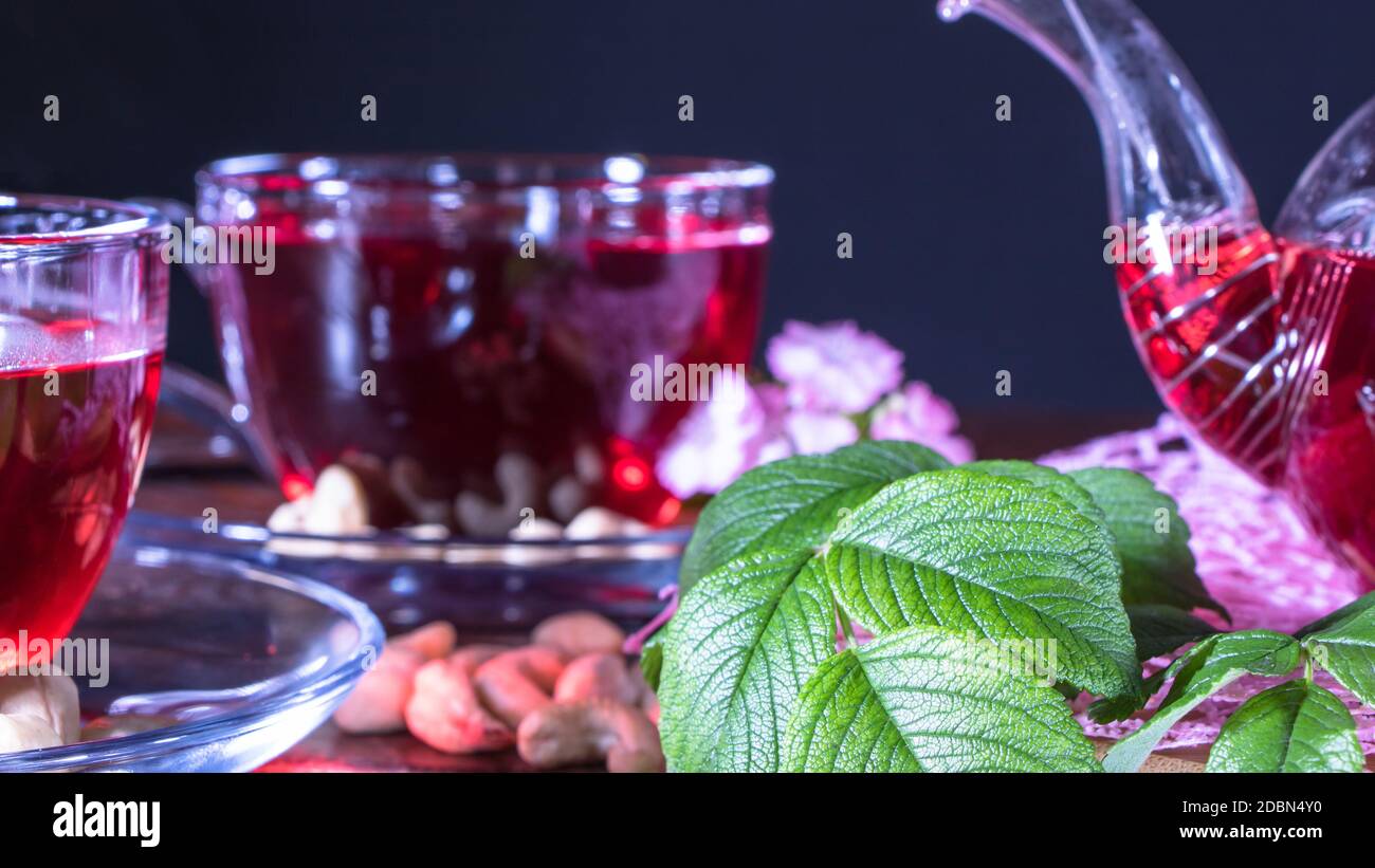 English tea. Red hot hibiscus tea in glass mug. Tea time: cup of tea ...
