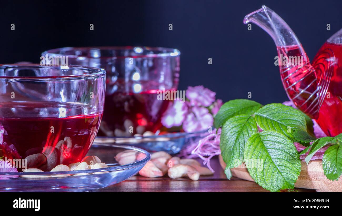 Hibiscus Red tea mug with carnation flowers close-up horizontal photo ...