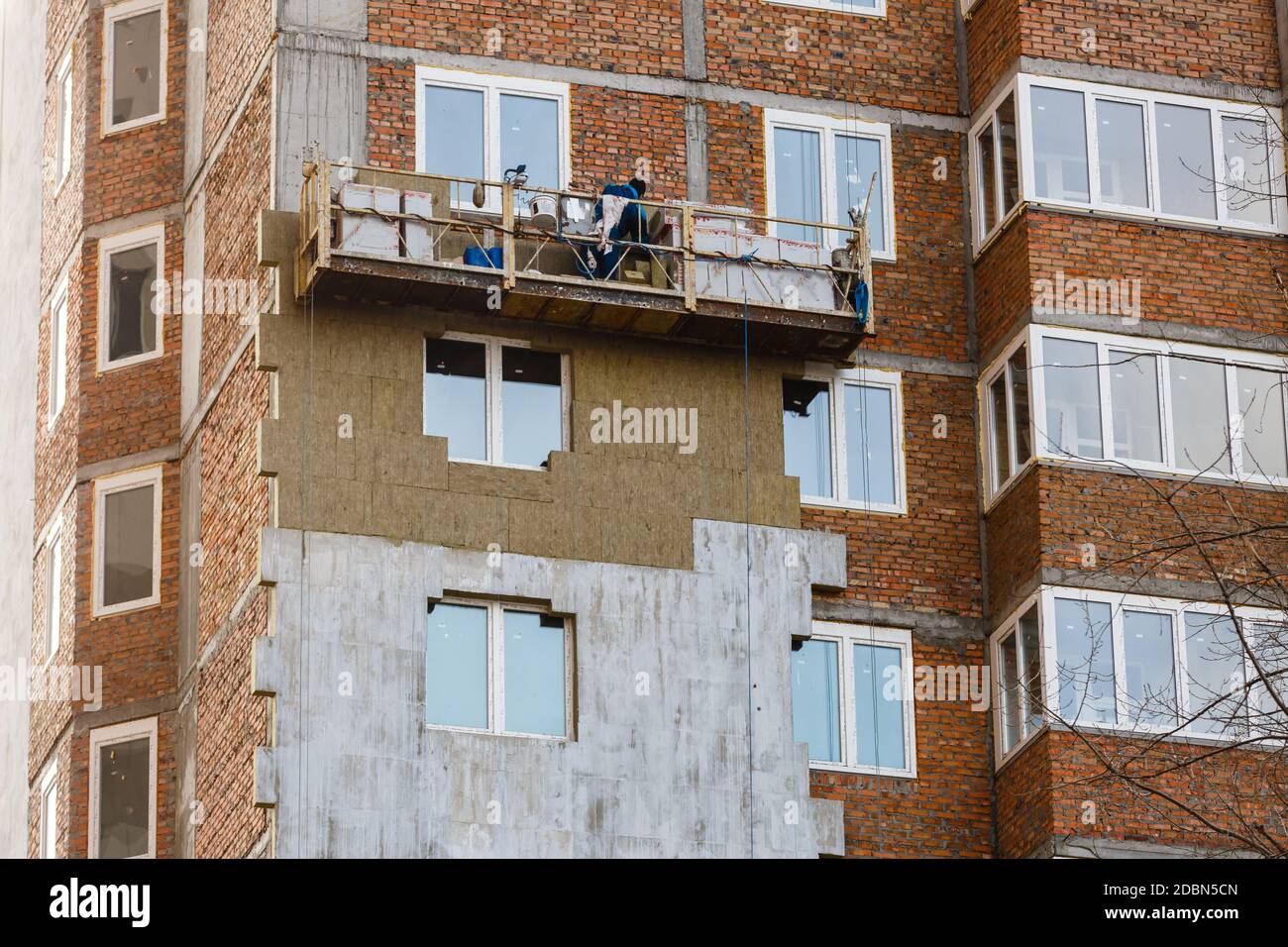 Construction workers working on wooden scaffolding installing ...