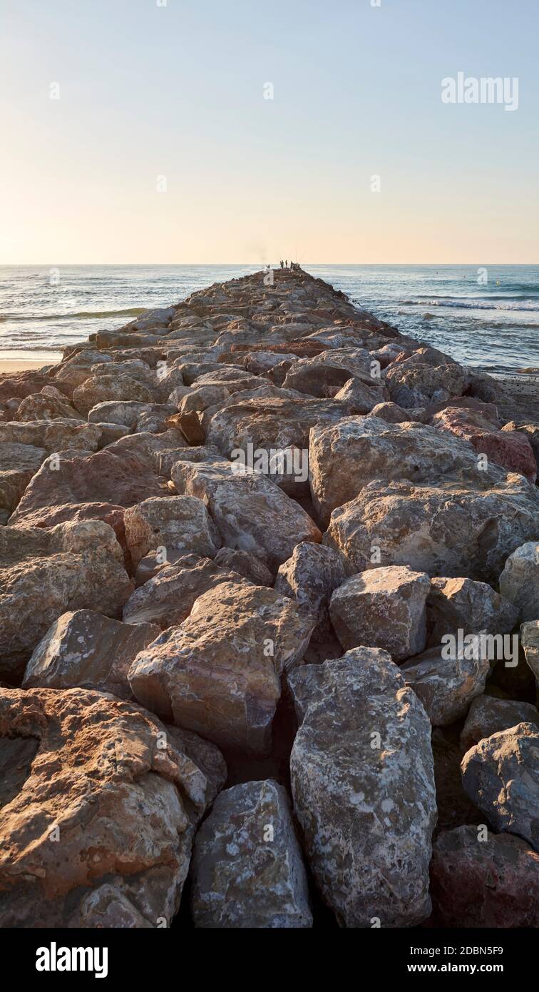 Stone path to the sea, sunrise, sunny, large rocks Stock Photo - Alamy