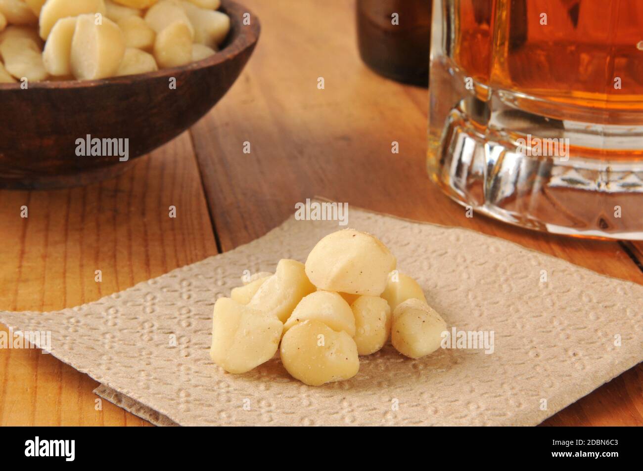 Macadamia nuts on a napkin on a bar counter with a mug of beer Stock ...
