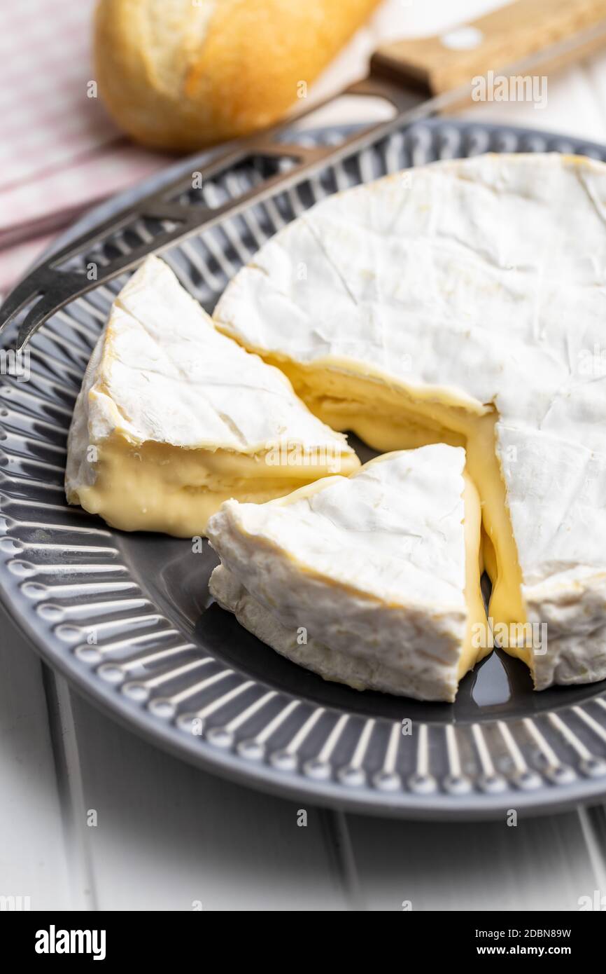 Brie cheese. White soft cheese with white mold on plate Stock Photo - Alamy
