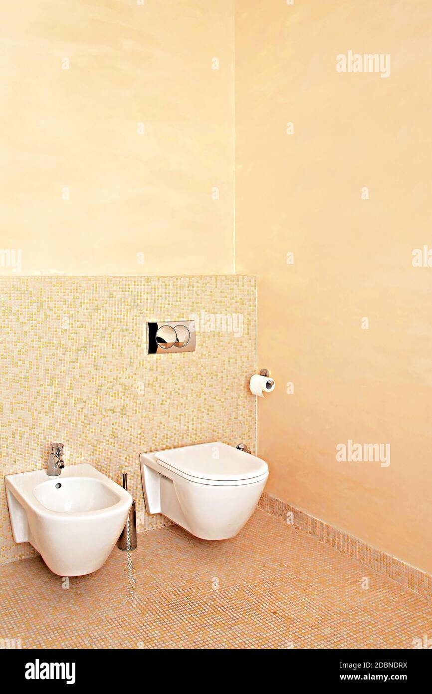 Interior shot of contemporary toilet with beige tiles Stock Photo - Alamy