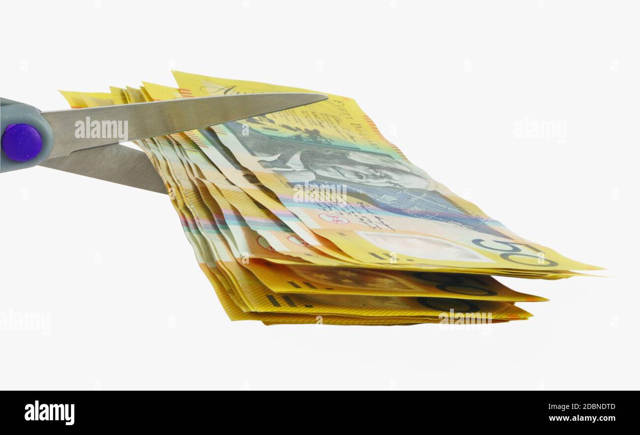 scissors cutting money over white background Stock Photo - Alamy