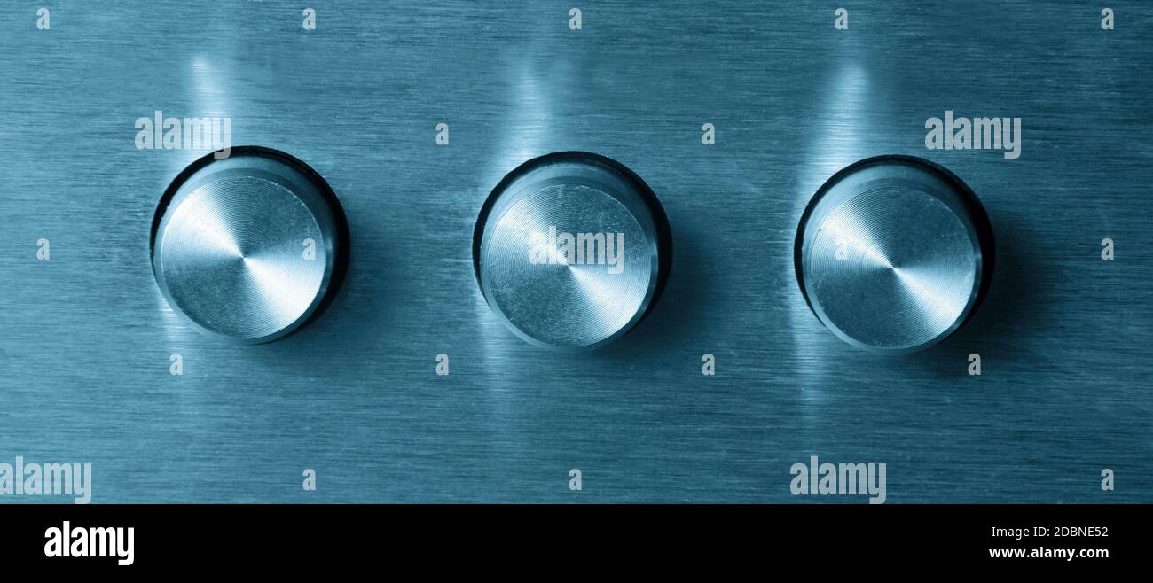 closeup of three electronic round switches Stock Photo - Alamy