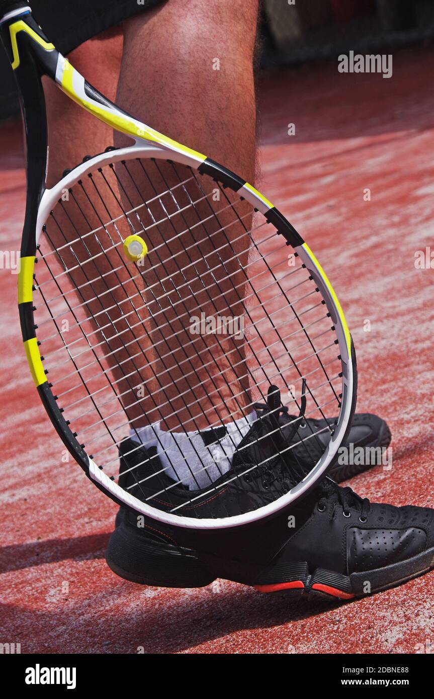 tennis player legs with racket Stock Photo - Alamy