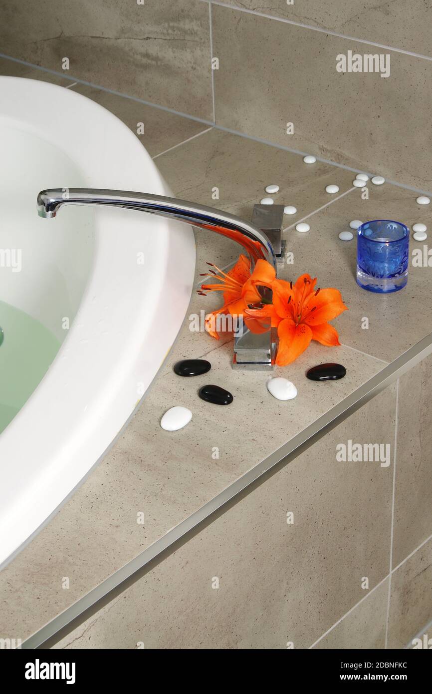 water tap with flowers in spa salon Stock Photo - Alamy