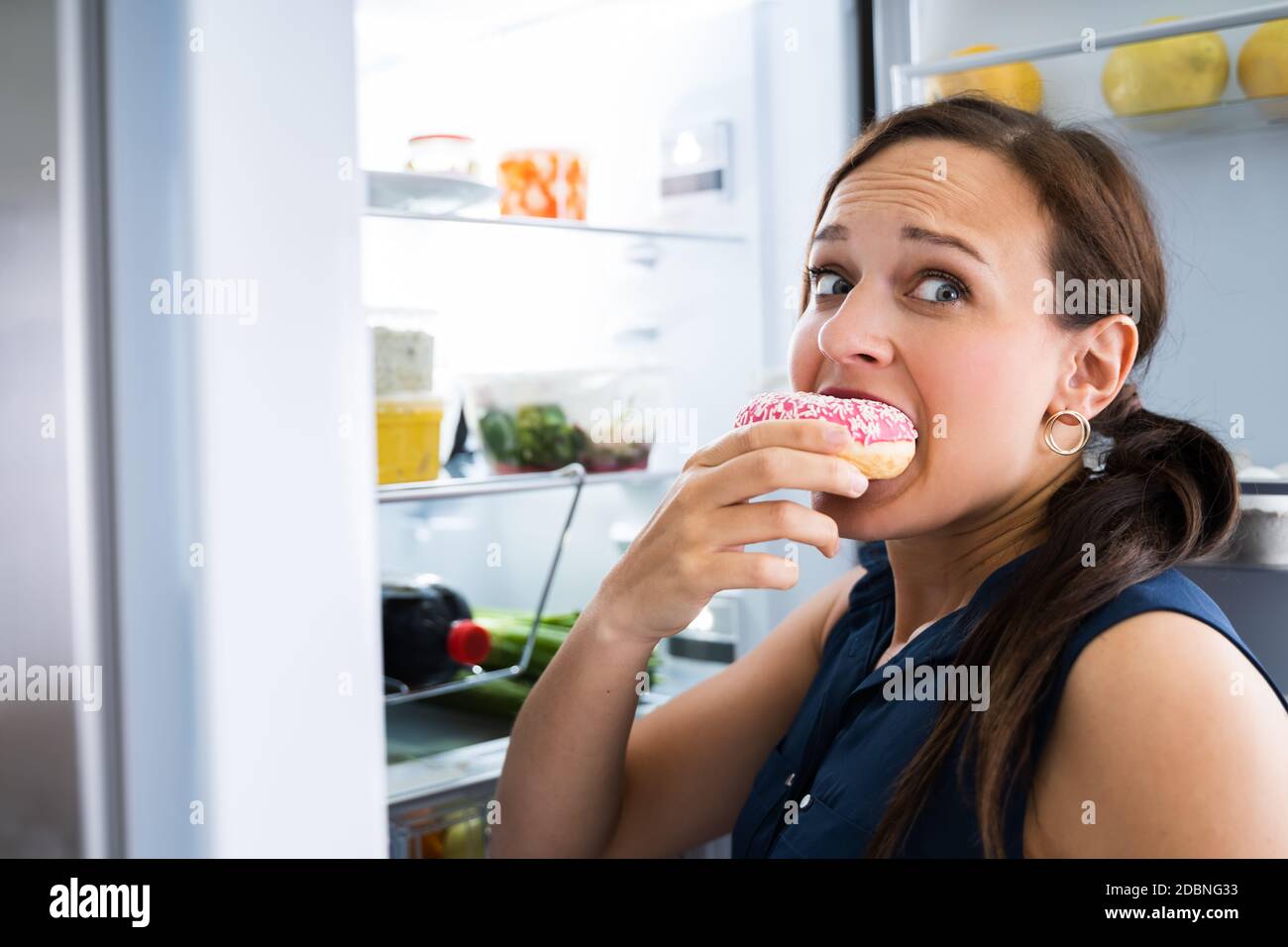 Woman eating donuts hi-res stock photography and images - Alamy