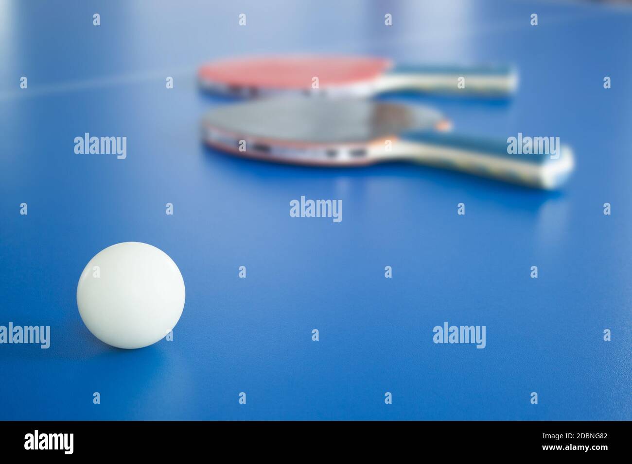 White ping-pong ball with rackets on background, table tennis ...