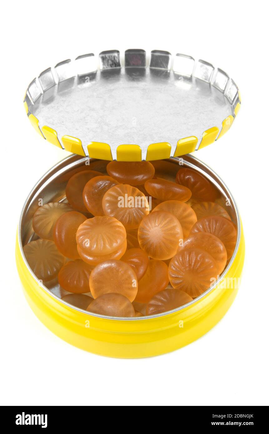 yellow candies in yellow metal container Stock Photo - Alamy