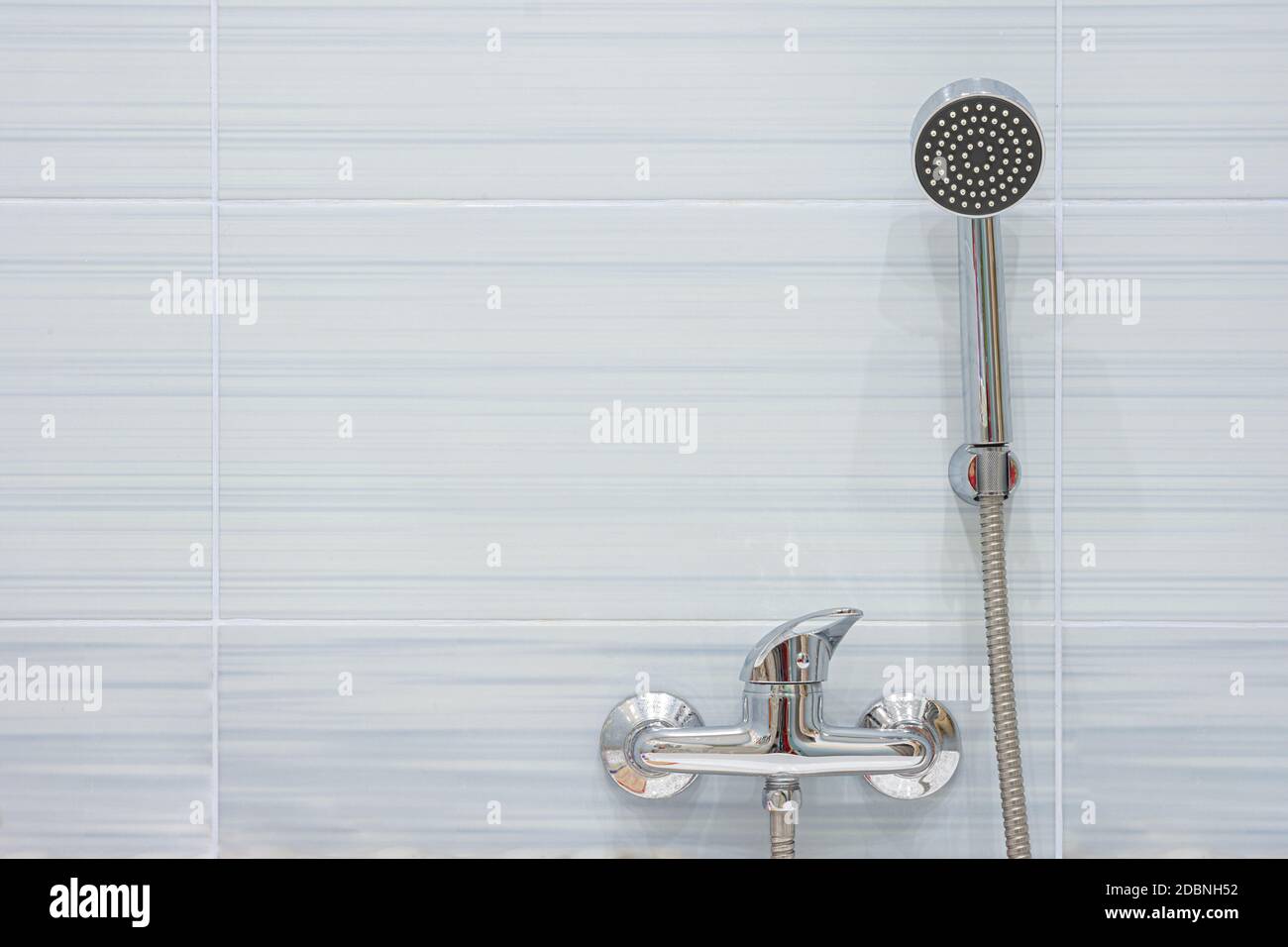 Blue tiled shower mixer and shower head Stock Photo - Alamy