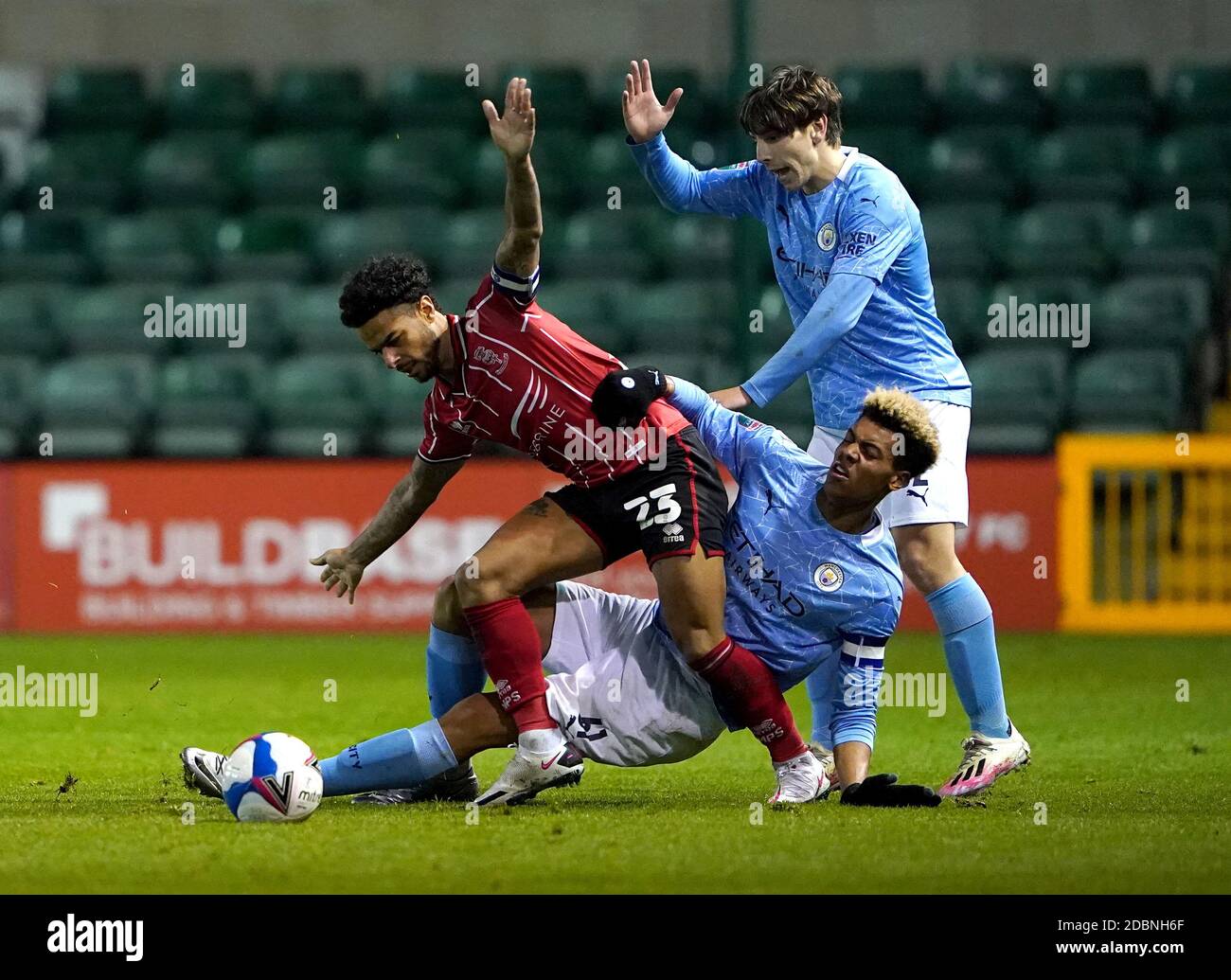 Lincoln City’s Liam Bridcutt battles for the ball with Manchester City ...