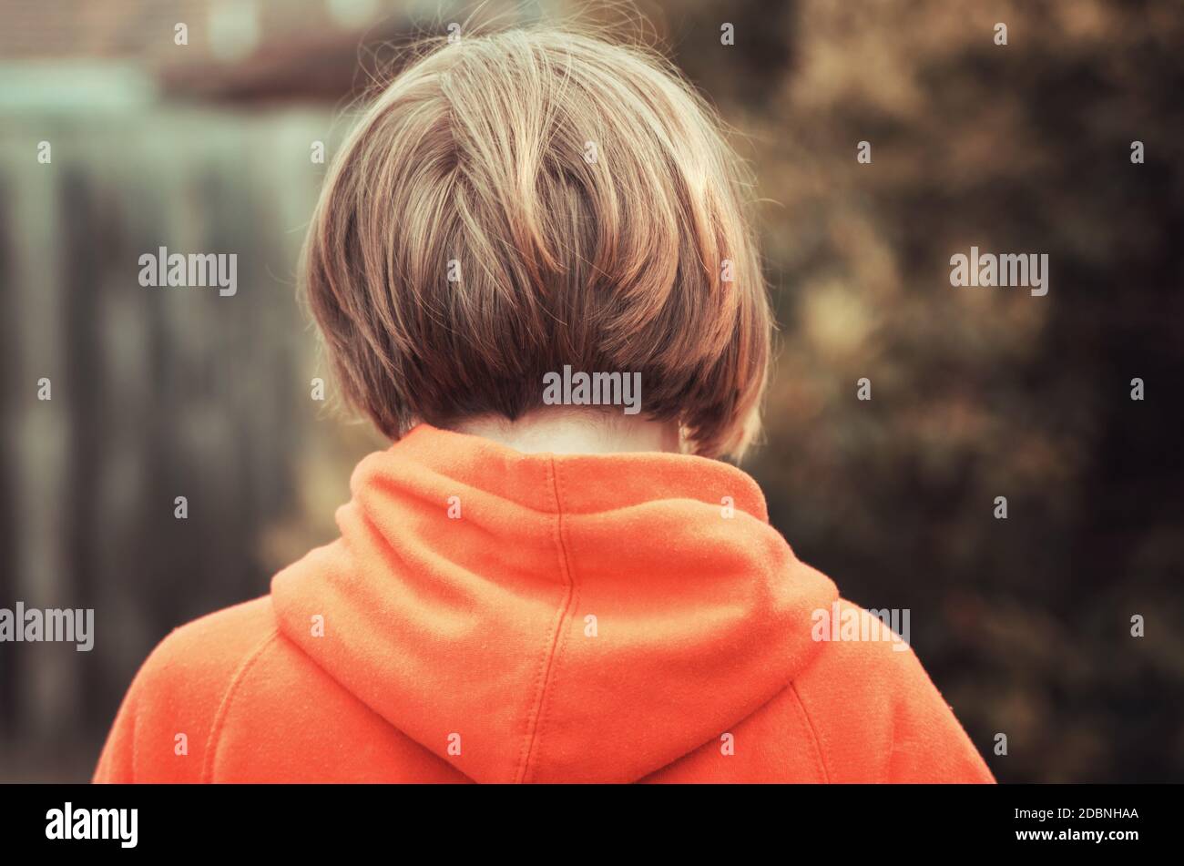 back view of girl with jacket hood outside Stock Photo - Alamy