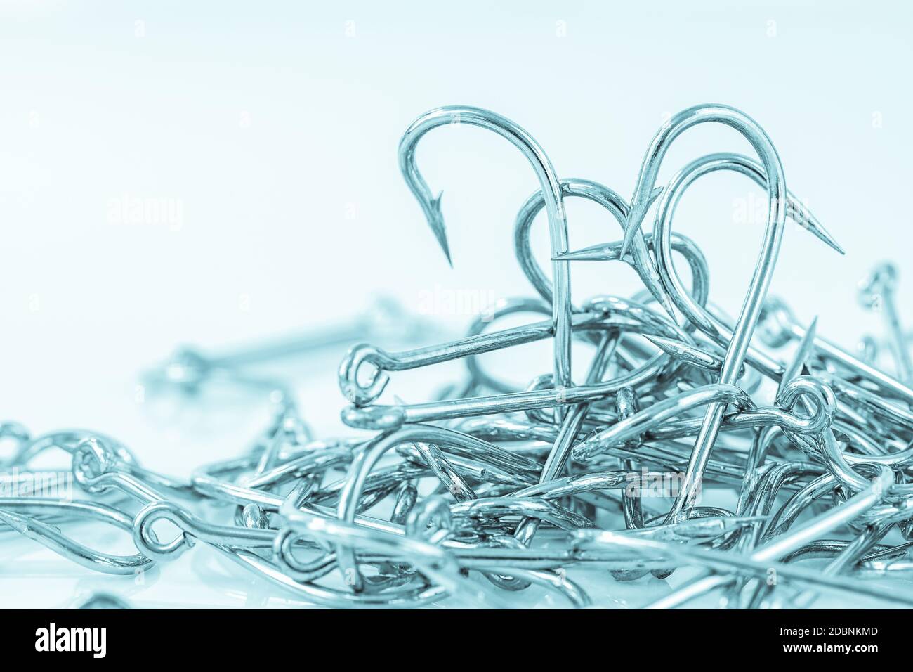 Close up shot Pile of fish hook on a white background Stock Photo - Alamy
