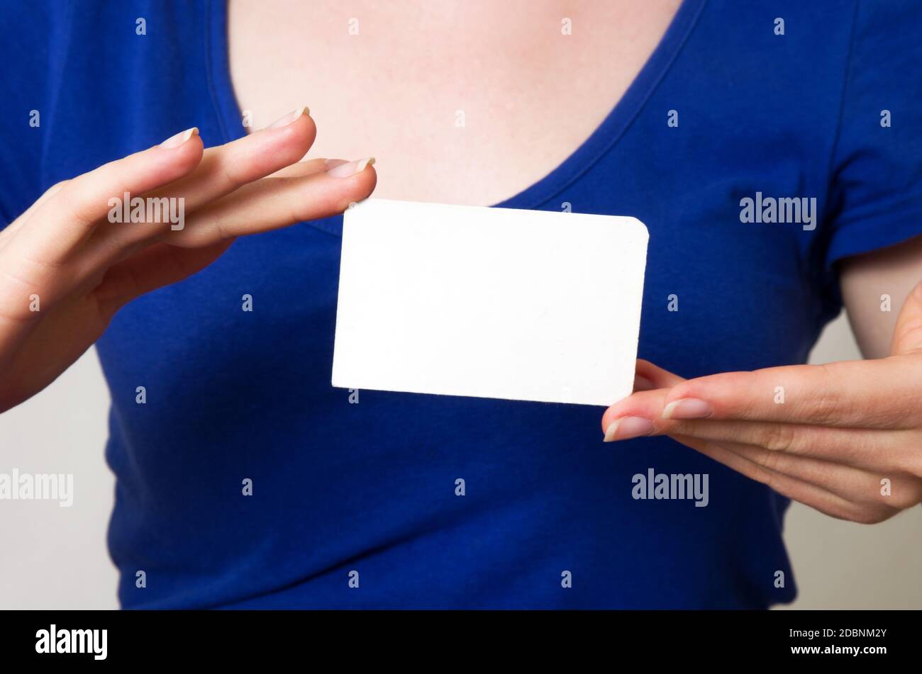female hands holding white card for text Stock Photo - Alamy