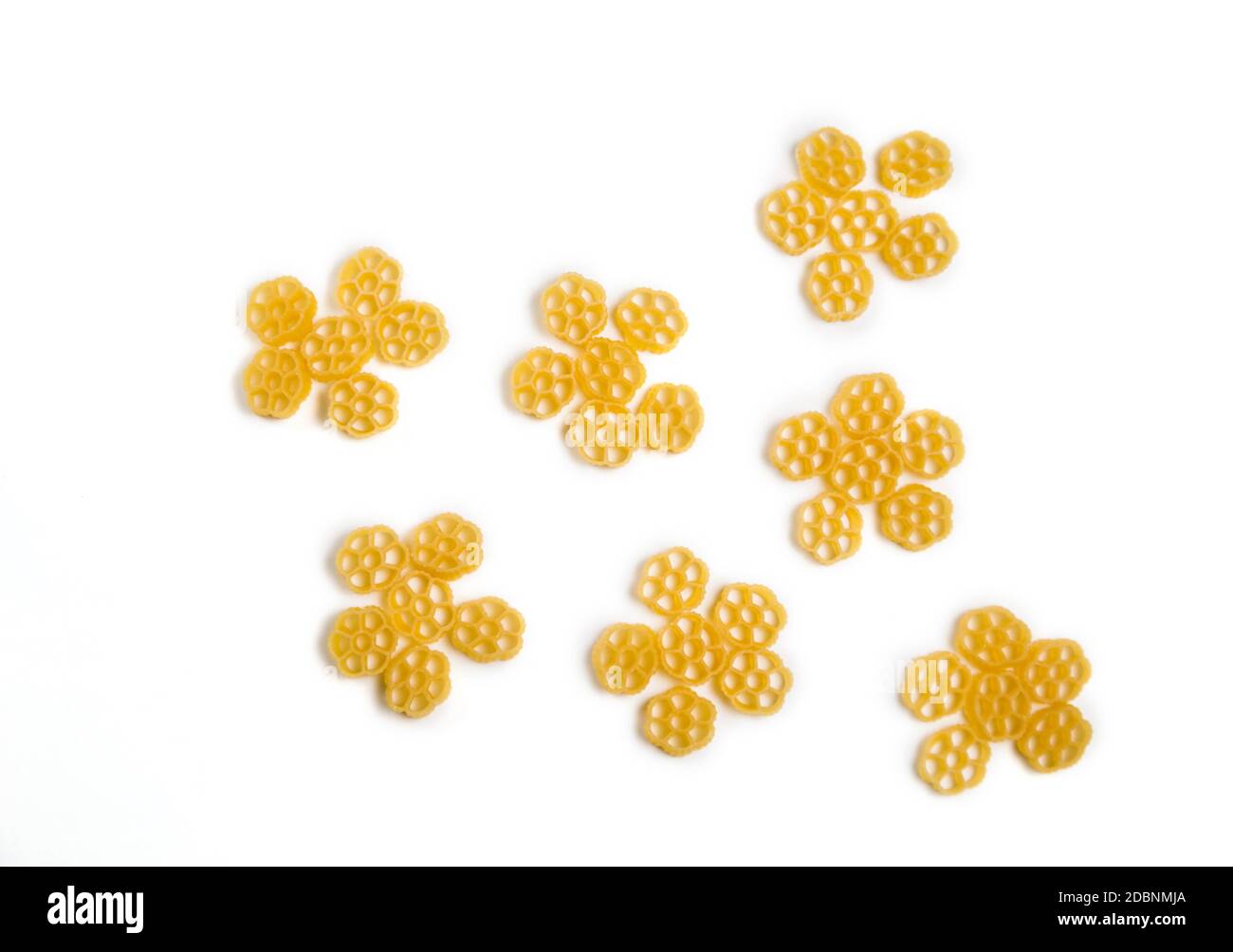 Flower shape made of raw Italian pasta isolated on white background ...