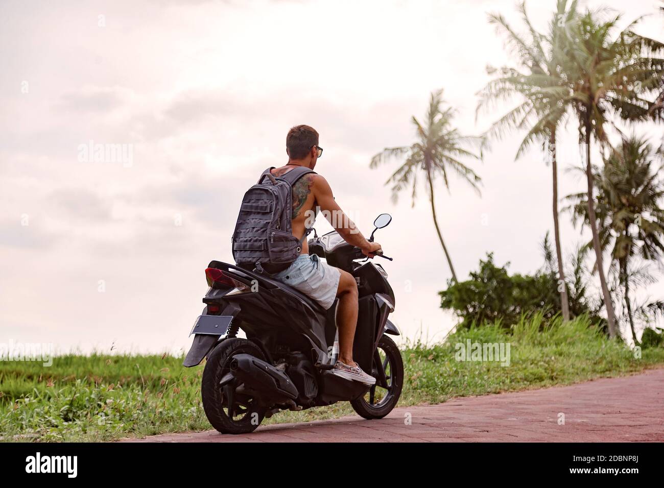 Man driving motorcycle on road, Bali, Indonesia Stock Photo - Alamy