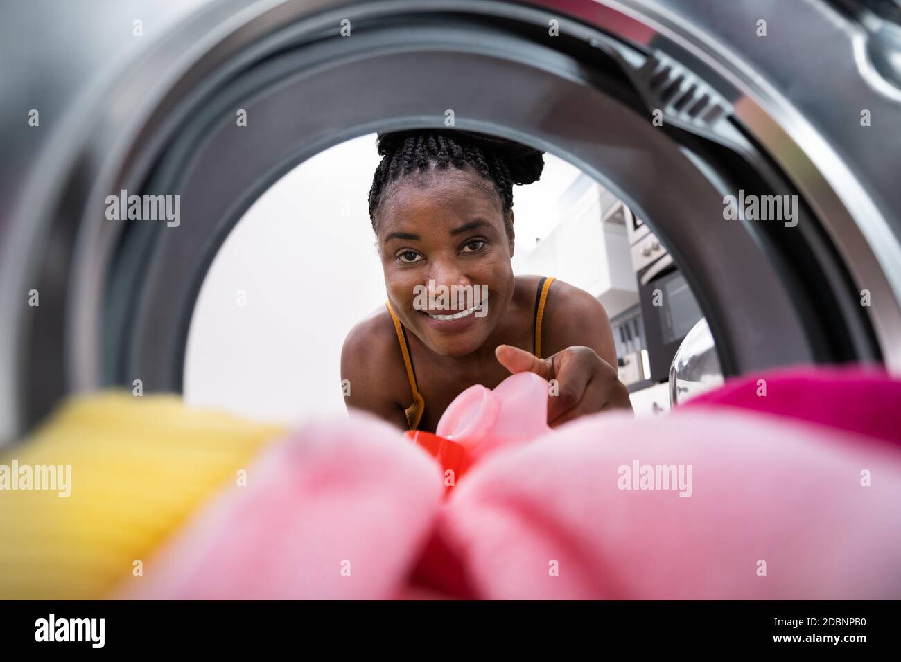 Woman using washing machine hi-res stock photography and images - Alamy