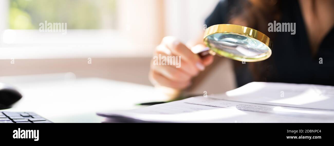 Auditor Investigating Corporate Fraud Using Magnifying Glass Stock ...