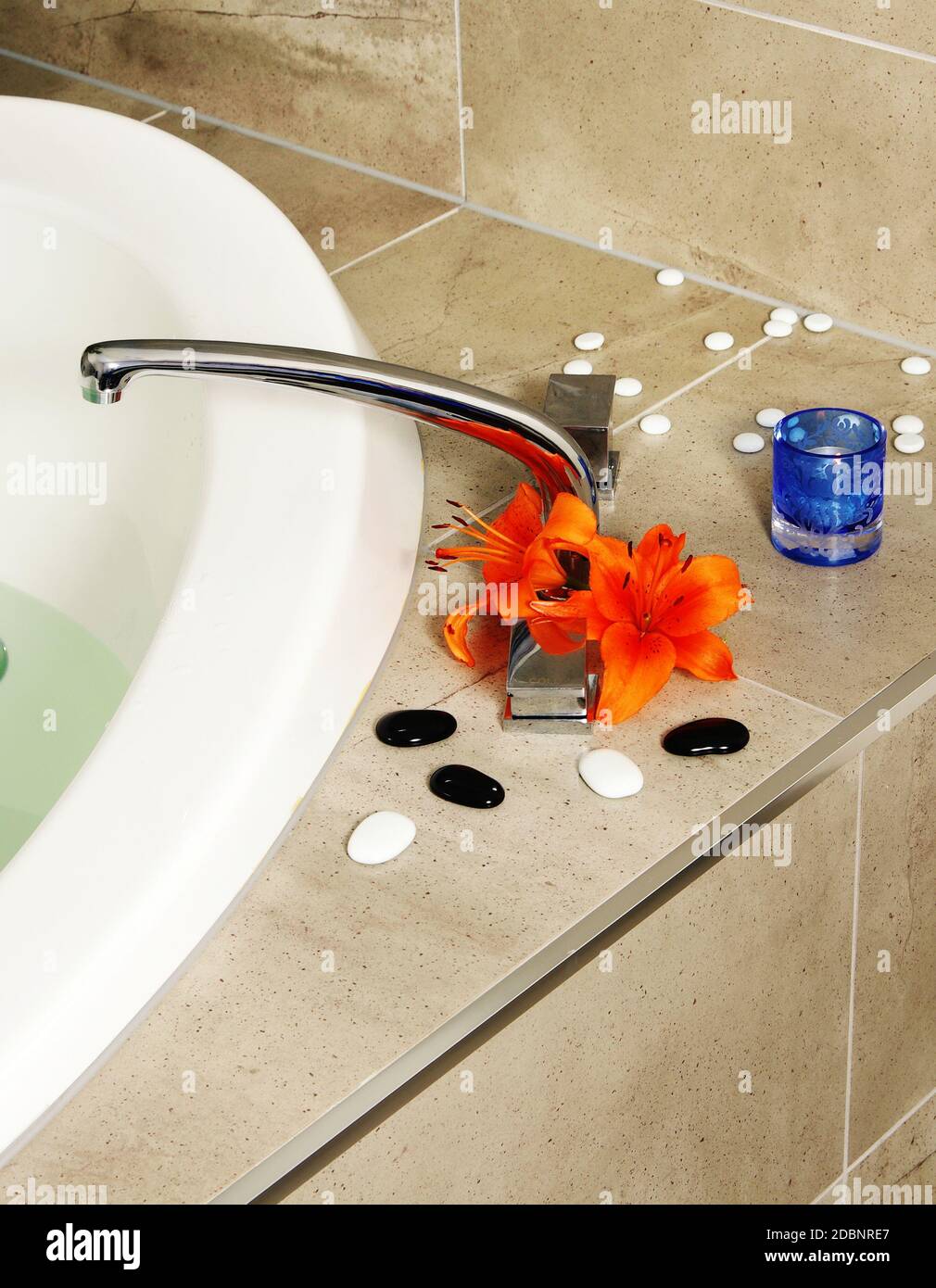 water tap with flowers in spa salon Stock Photo - Alamy