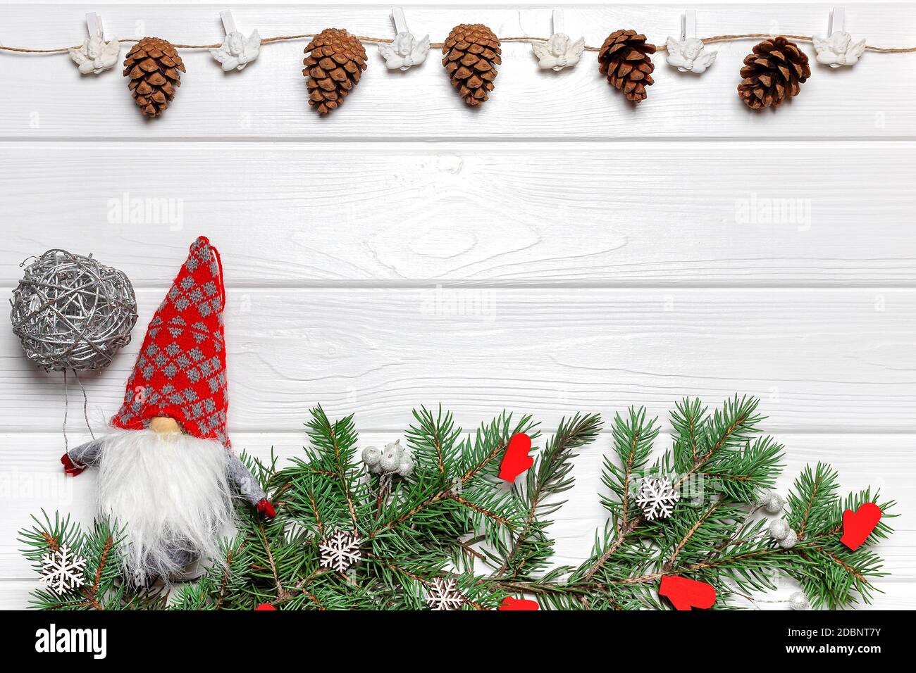 New Year gnome with silver ball, pine branches with mitten and ...