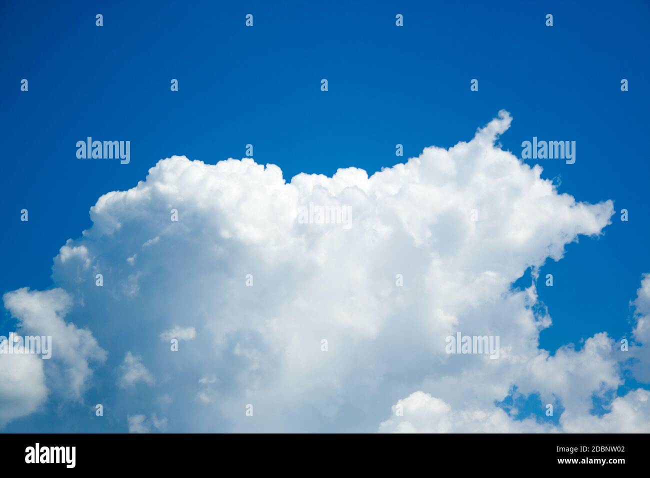 Huge clouds in blue sky lit by the sun, not windy Stock Photo - Alamy