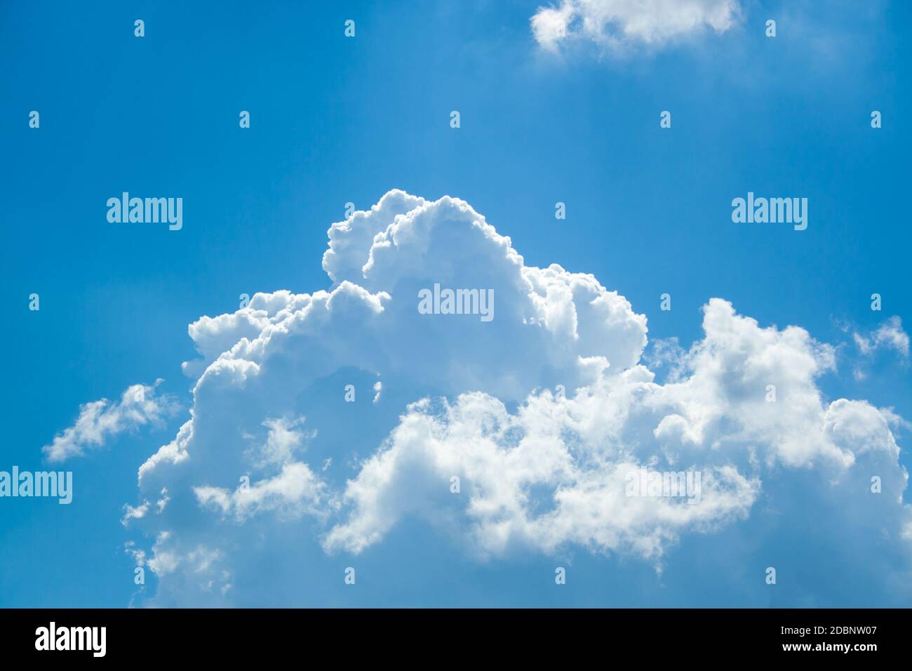 Huge clouds in blue sky lit by the sun, not windy Stock Photo - Alamy