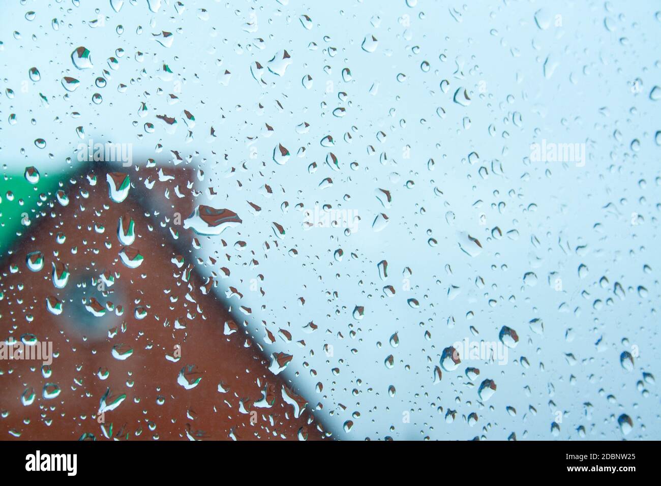Abstract texture of raindrops at rainy day on glass with house on ...
