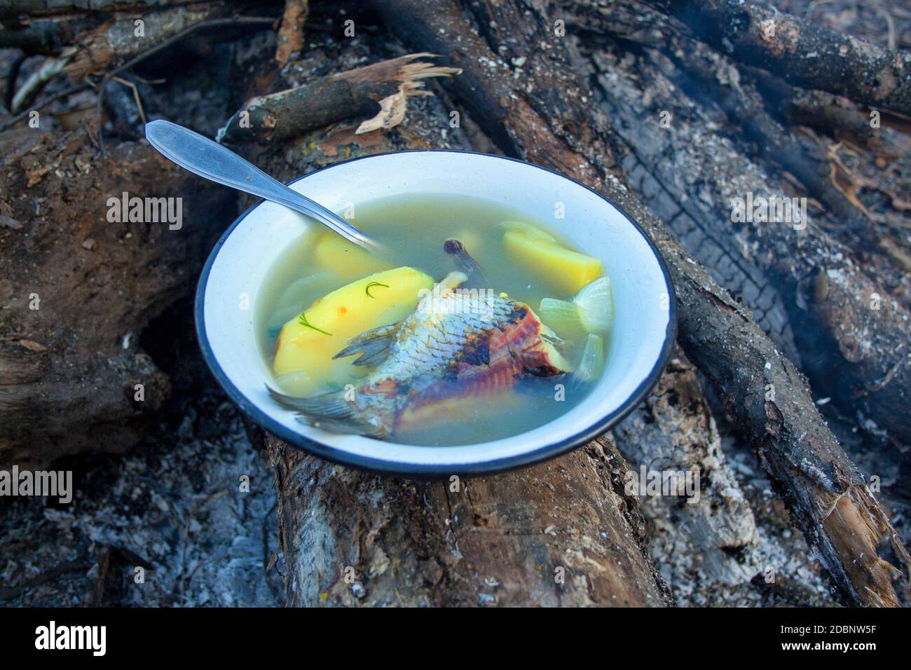 Fish soup in iron plat stands near the bonfire Stock Photo - Alamy