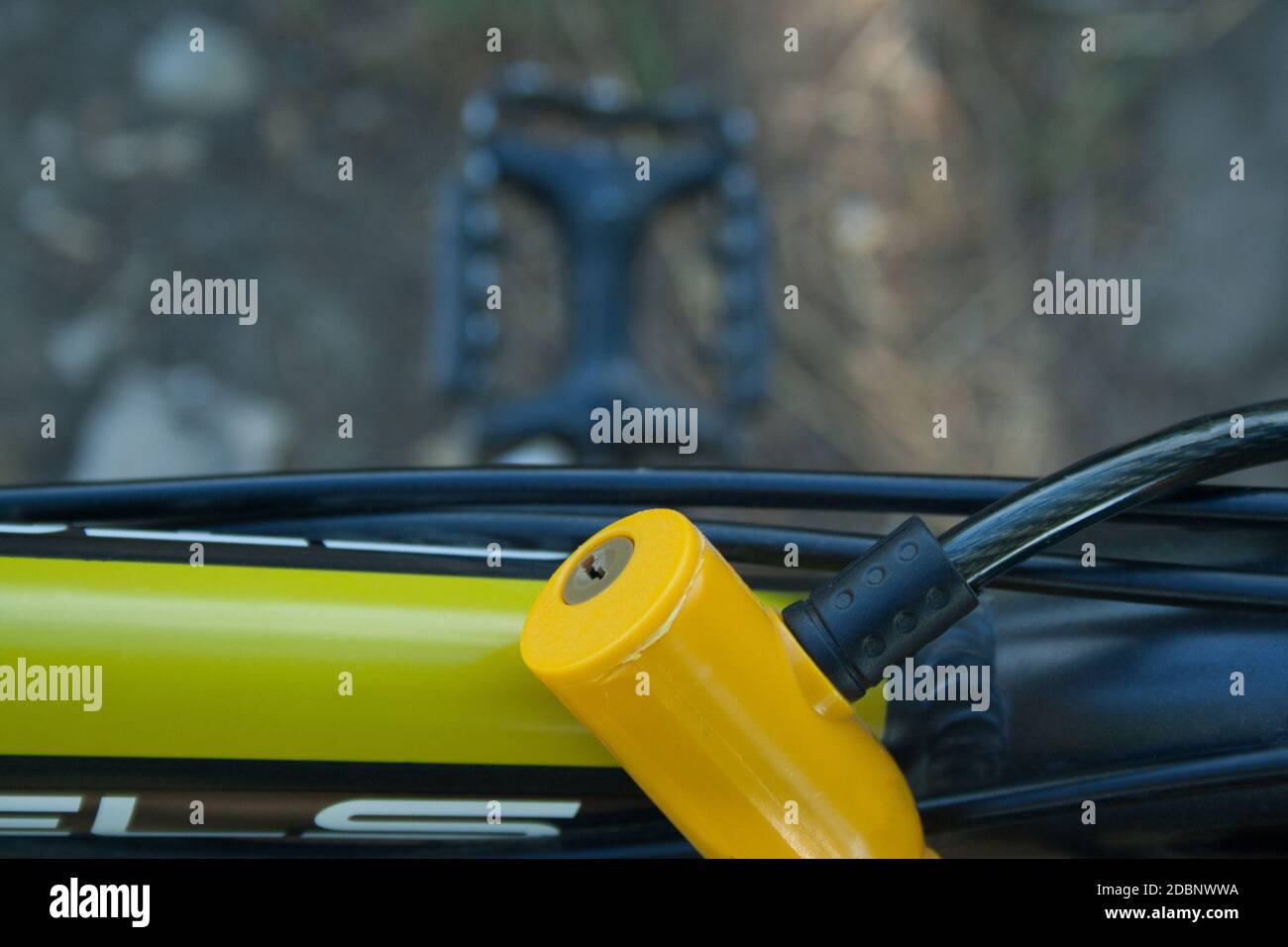 Yellow plastic lock fixed on a bicycle close up Stock Photo - Alamy