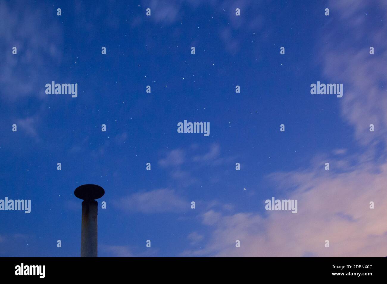 Blue night sky on the roof with chimney Stock Photo - Alamy
