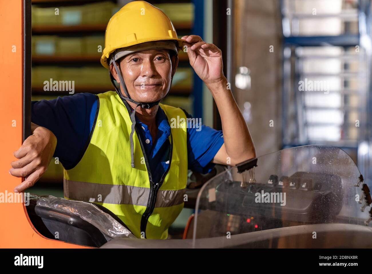 Portrait asian male warehouse worker using forklift truckin large ...