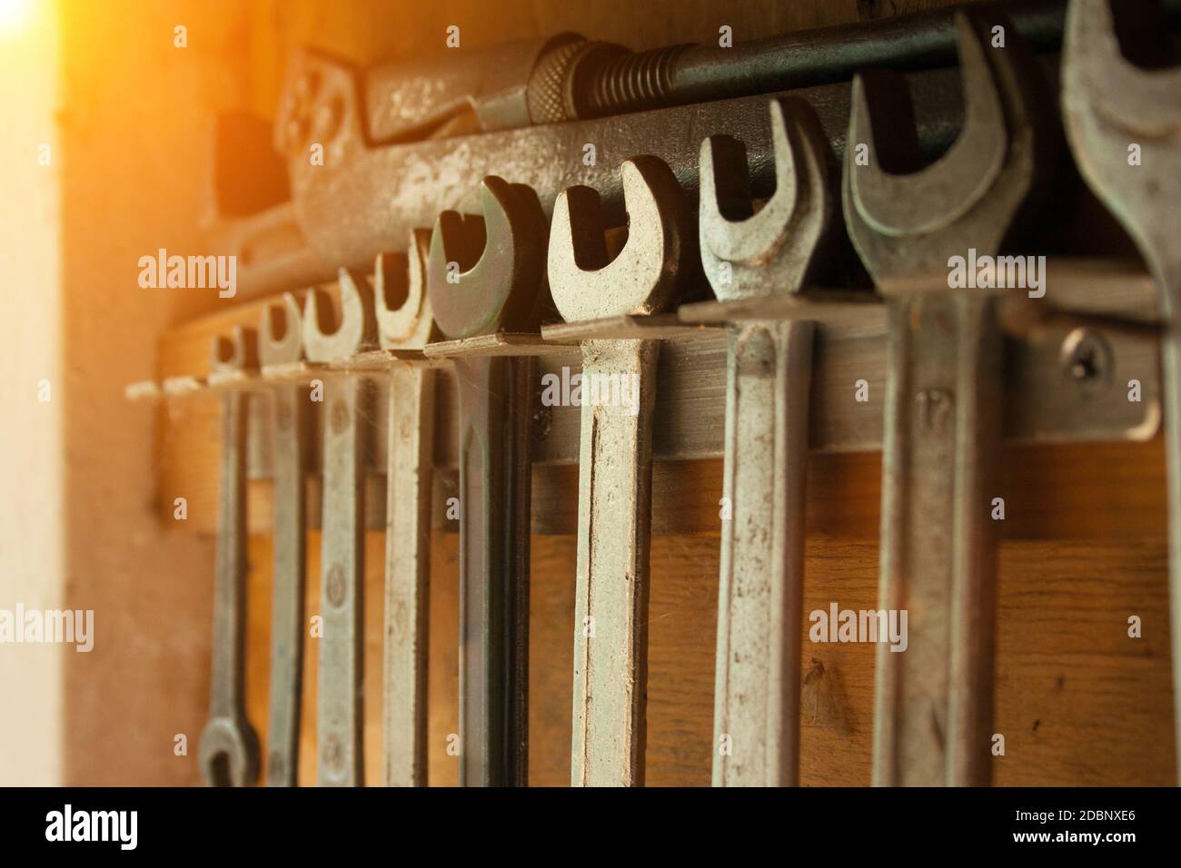 Old rusty spanners are hanging in a row in the shed Stock Photo - Alamy