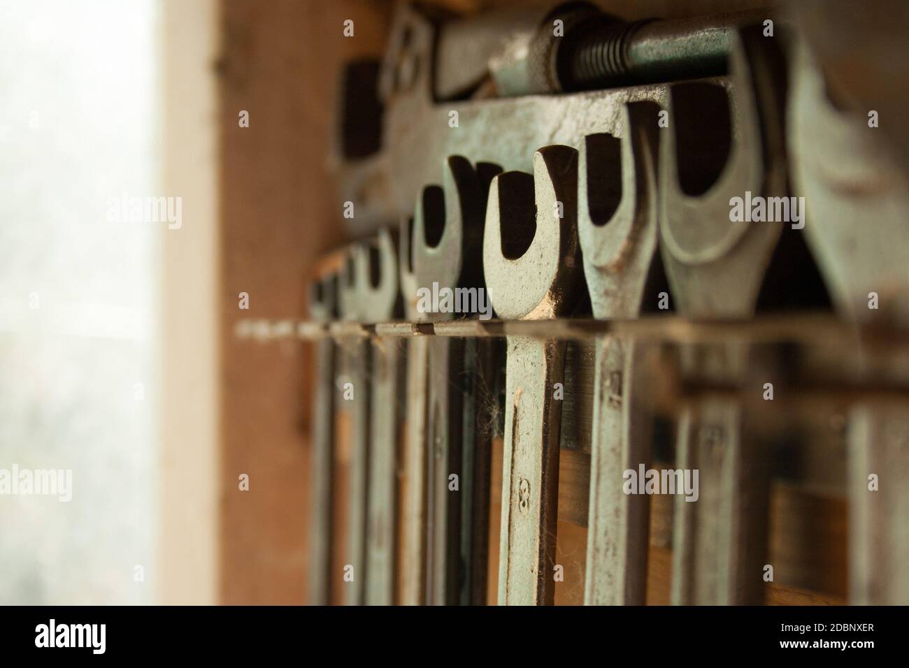 Old rusty spanners are hanging in a row in the shed Stock Photo - Alamy