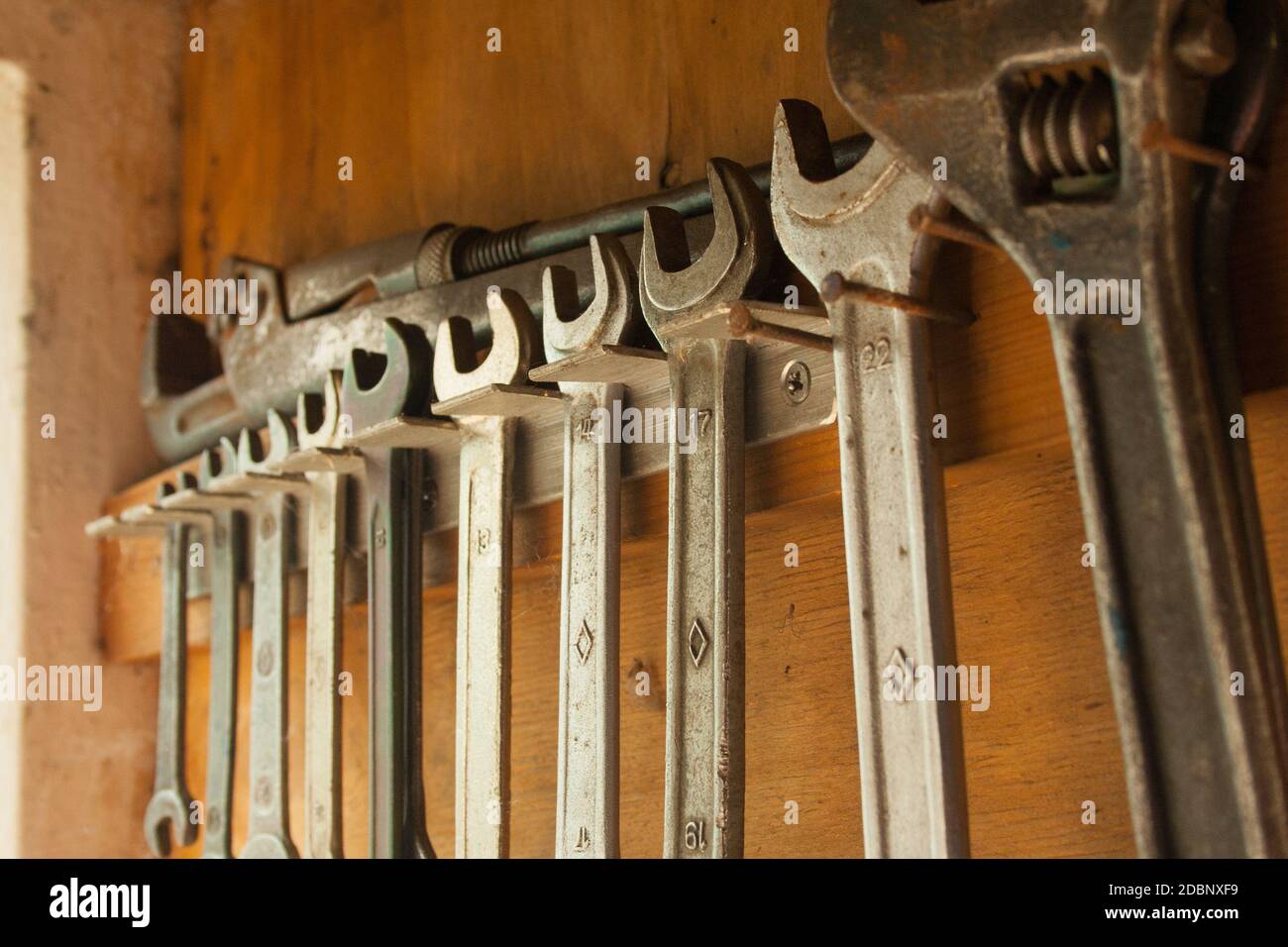 Old rusty spanners are hanging in a row in the shed Stock Photo - Alamy