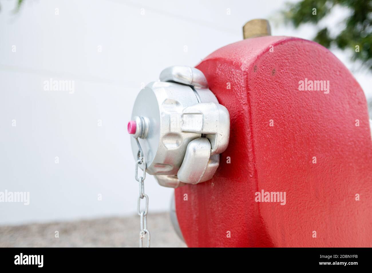 Red fire hydrant or fireplug connection for firefighters in public road ...