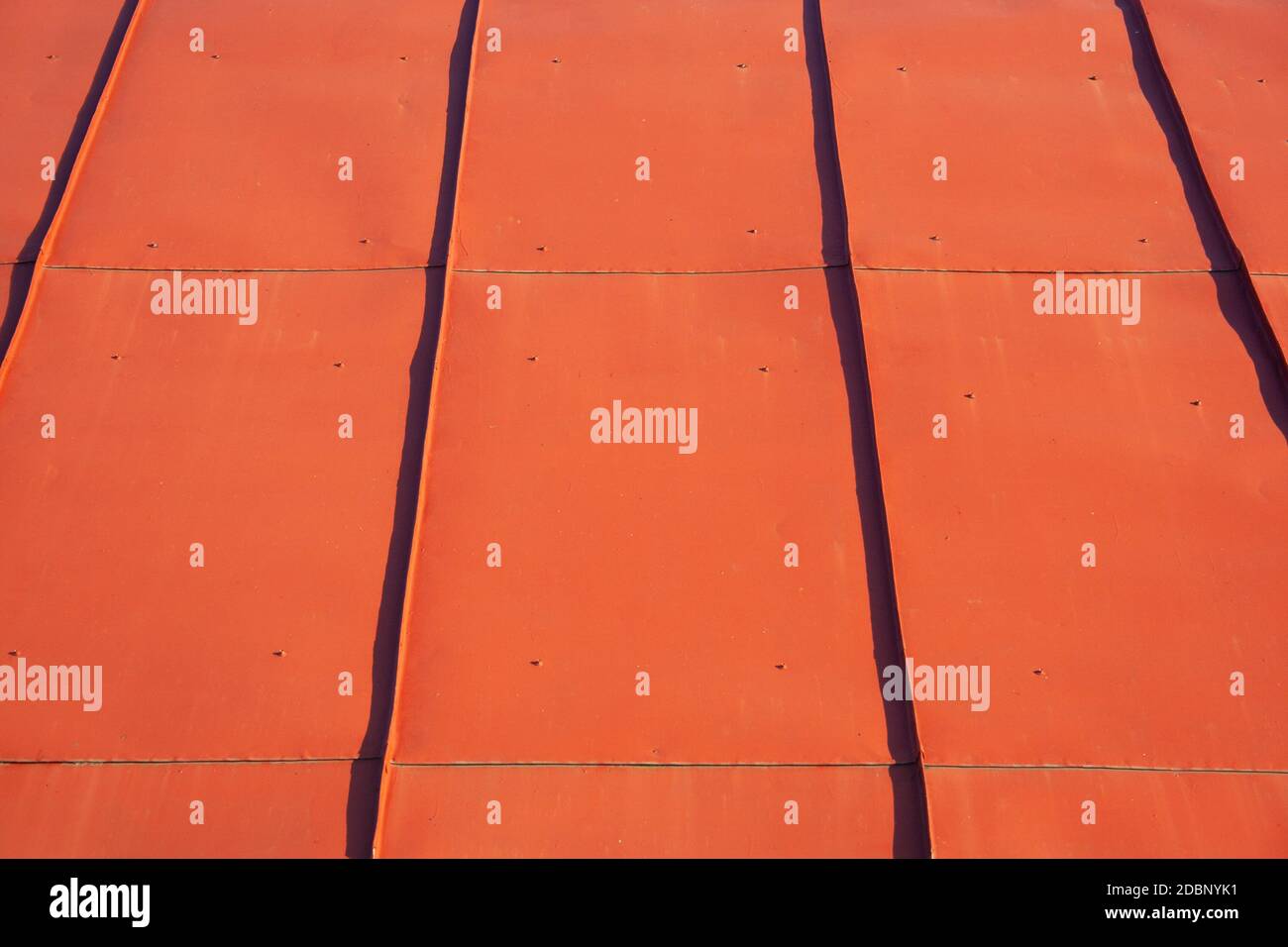 Red covered by metal plates roof at sunny day Stock Photo - Alamy