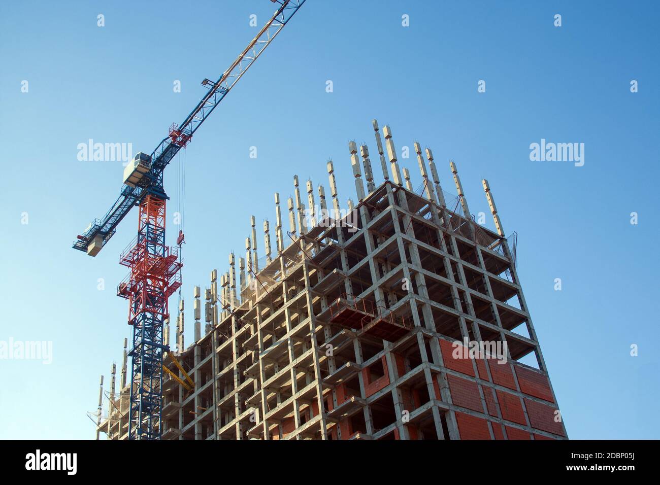 Construction crane in the process of building a new residential ...