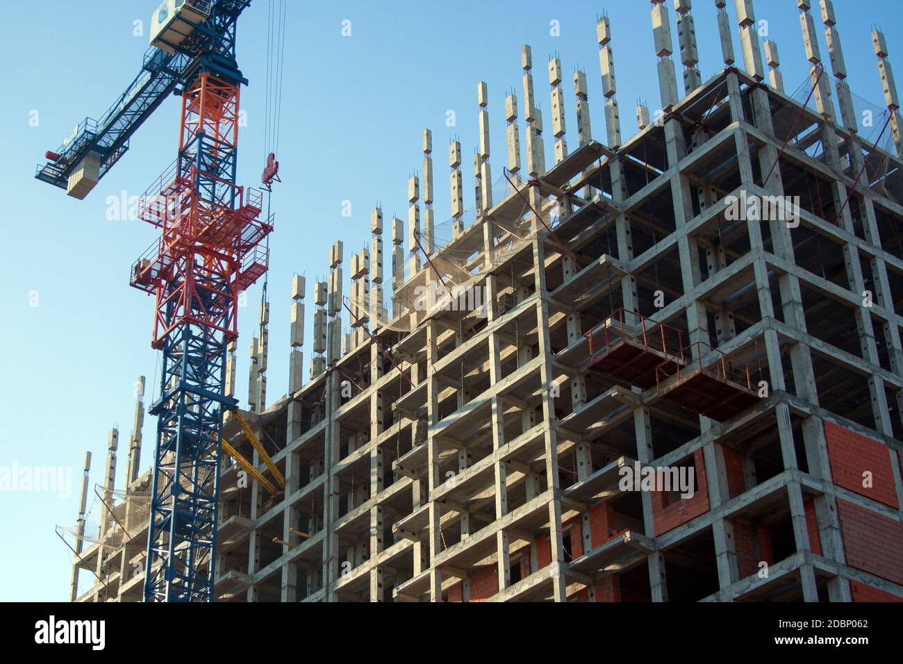 Construction crane in the process of building a new residential ...
