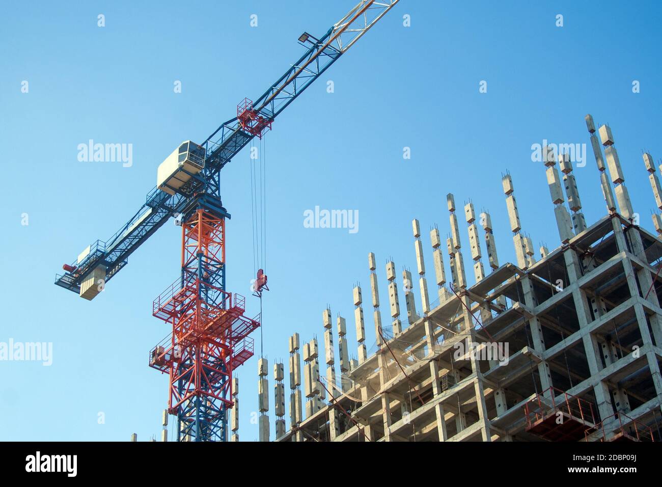 Construction crane in the process of building a new residential ...