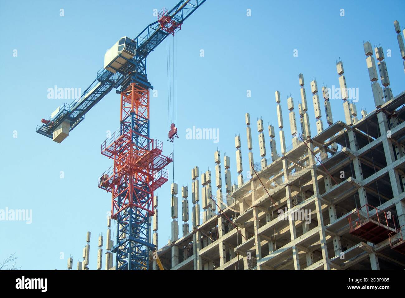 Construction crane in the process of building a new residential ...