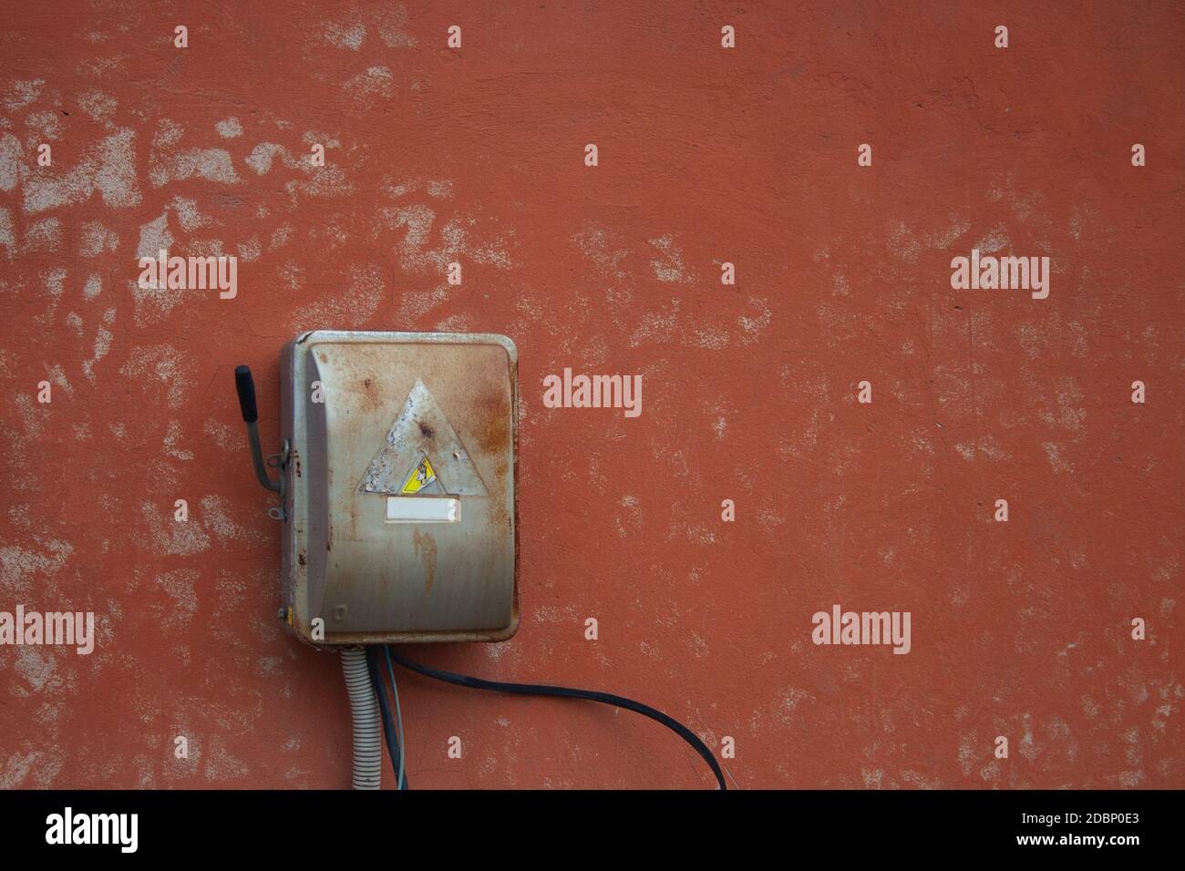 Old power box on red wall. Old electric box Stock Photo - Alamy