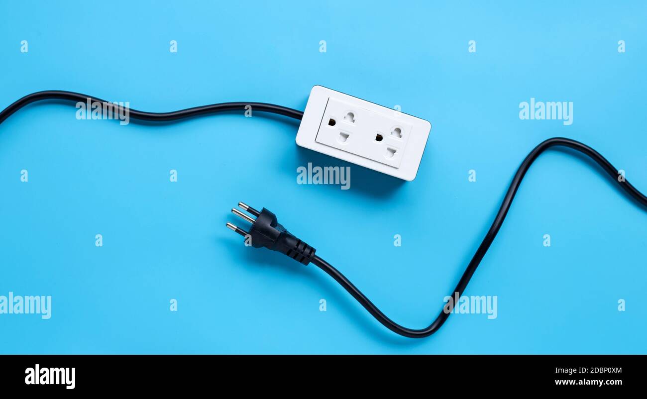 Electrical power strip and plug on blue background. Top view Stock ...