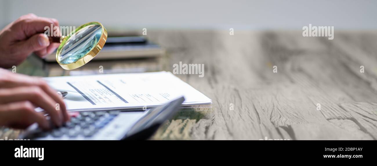 Tax Audit Using Magnifying Glass On Invoice Document Stock Photo - Alamy