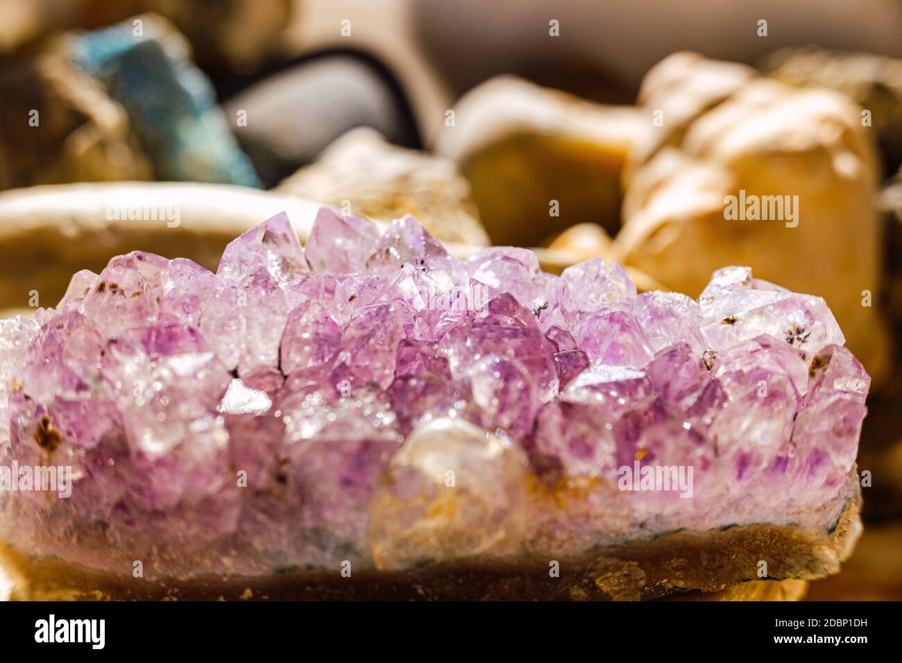 Amethyst rock on the table of a geology student Stock Photo - Alamy
