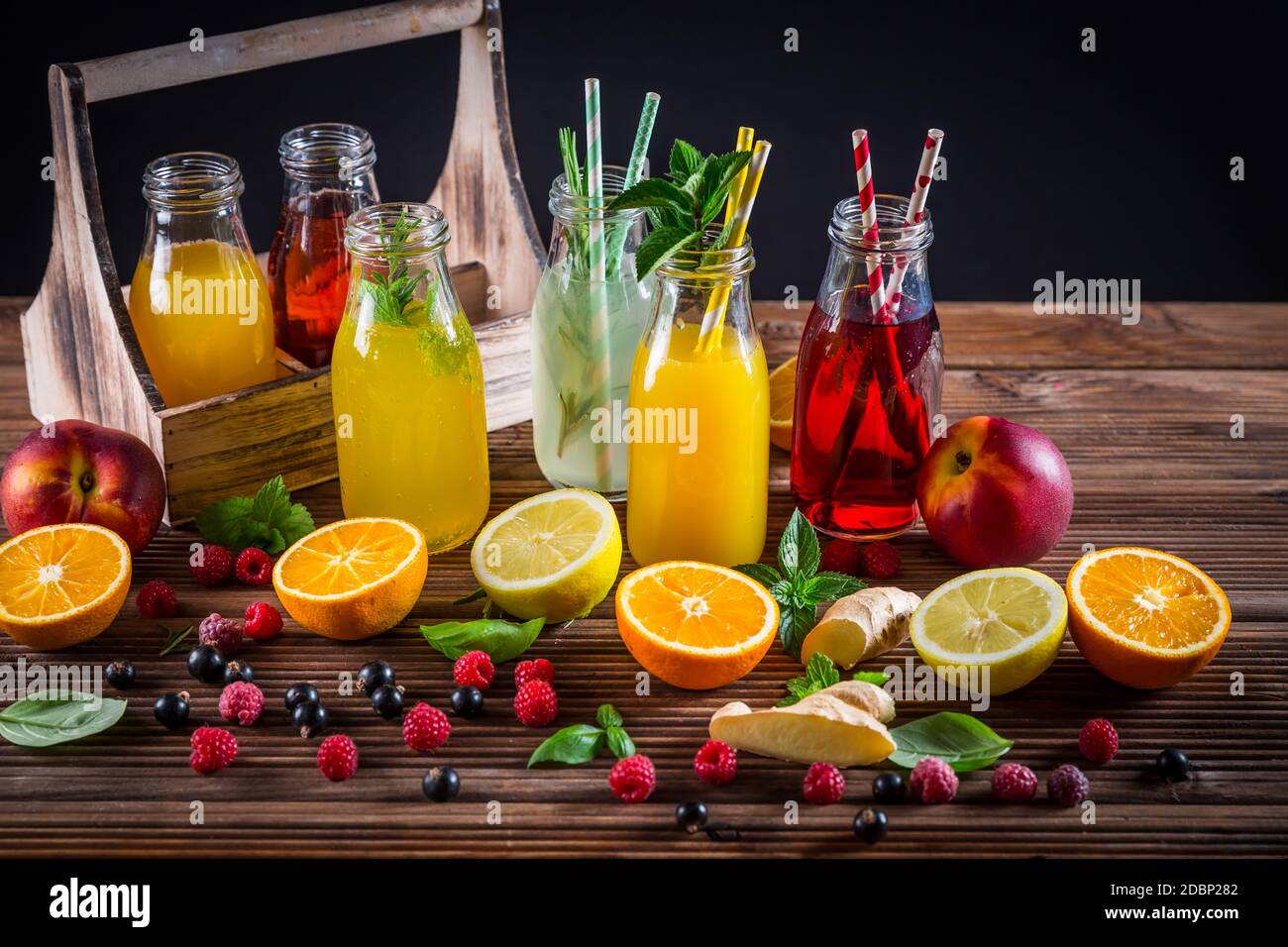 Assortment of juices and lemonades with fruits and herbs on wooden ...