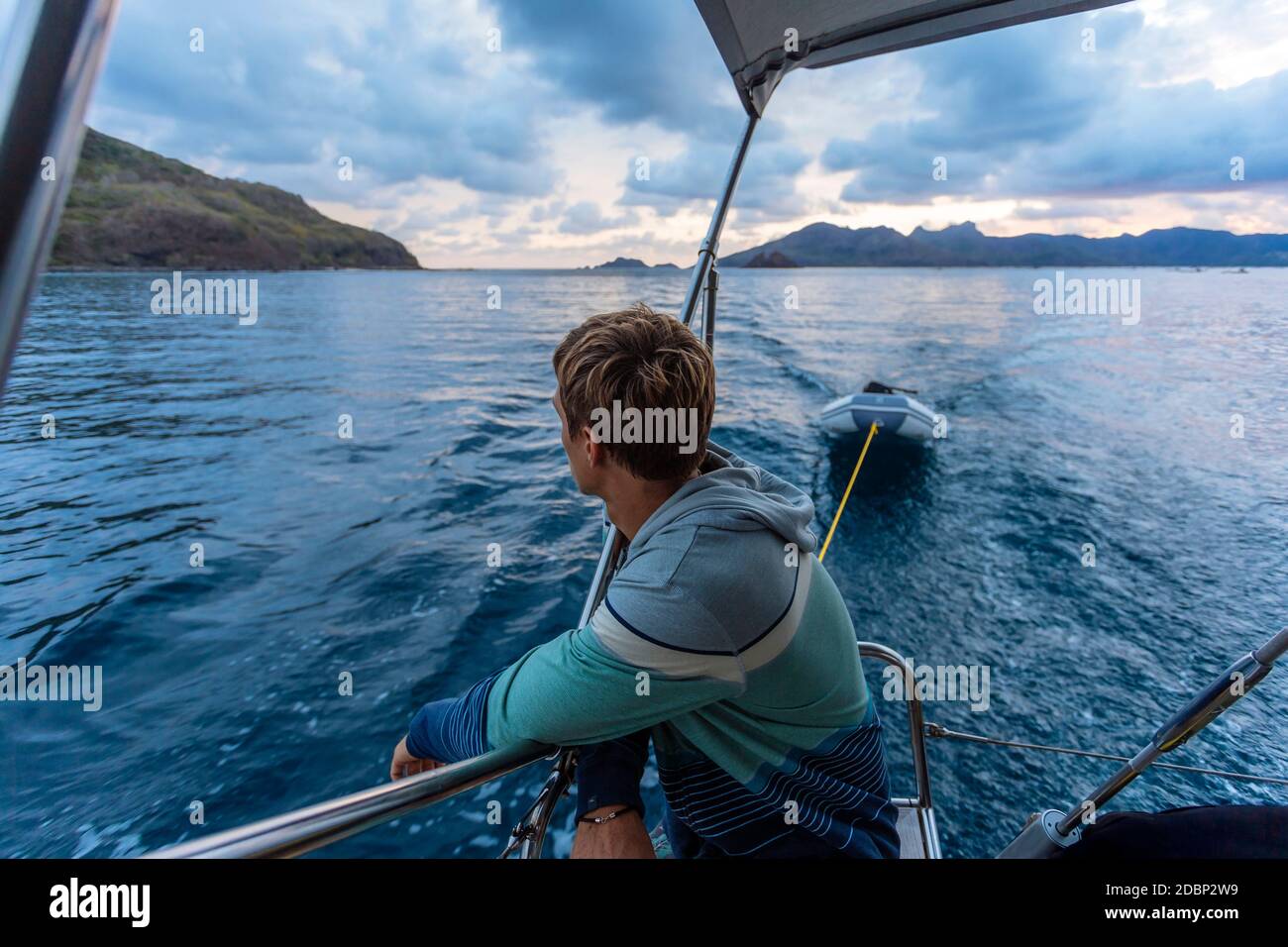 Man on sailboat sailing in sea, Lombok, Indonesia Stock Photo - Alamy