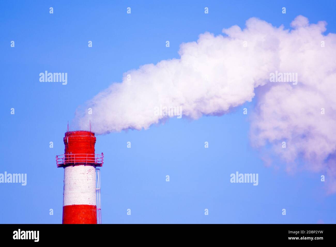 red pipe throws steam on blue sky background. Toned Stock Photo - Alamy